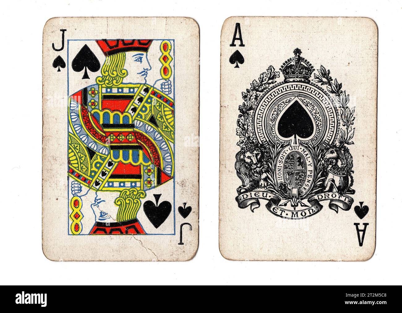 A pair of vintage playing cards showing an ace and jack of spades on a ...