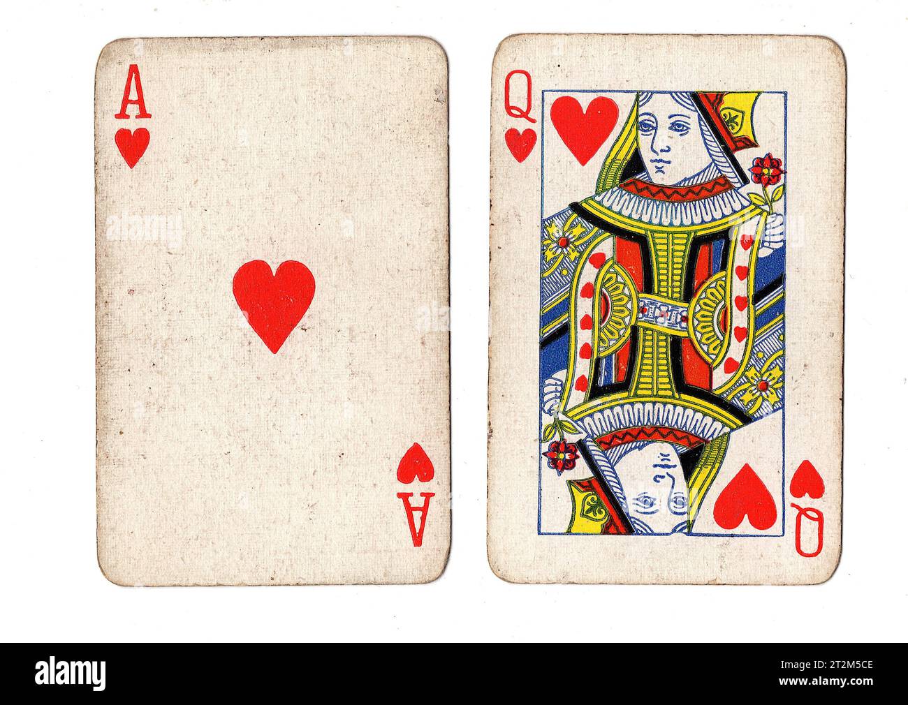A pair of vintage playing cards showing an ace and queen of hearts on a ...