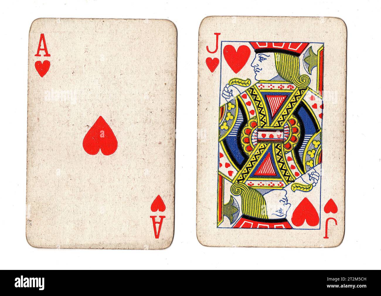 A pair of vintage playing cards showing an ace and jack of hearts on a ...