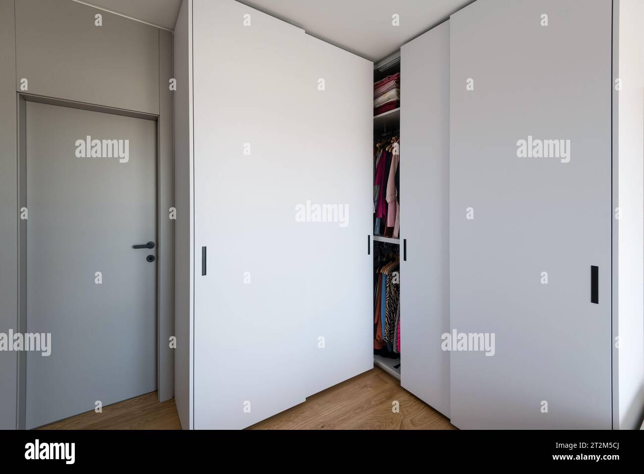 Gray wardrobe closets bedroom of small urban apartment Stock Photo - Alamy