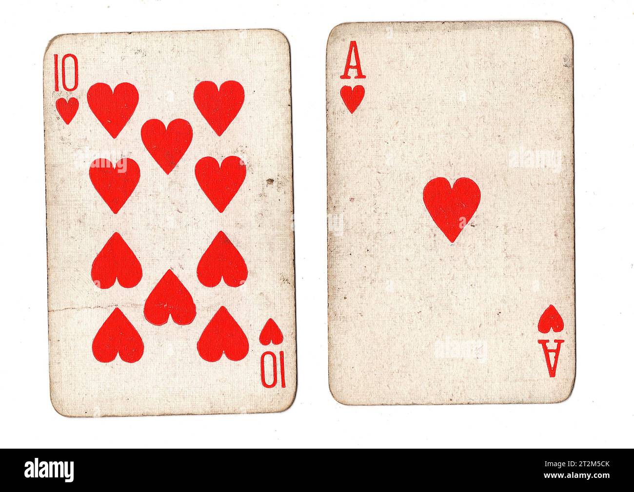 A pair of vintage playing cards showing an ace and ten of hearts on a ...