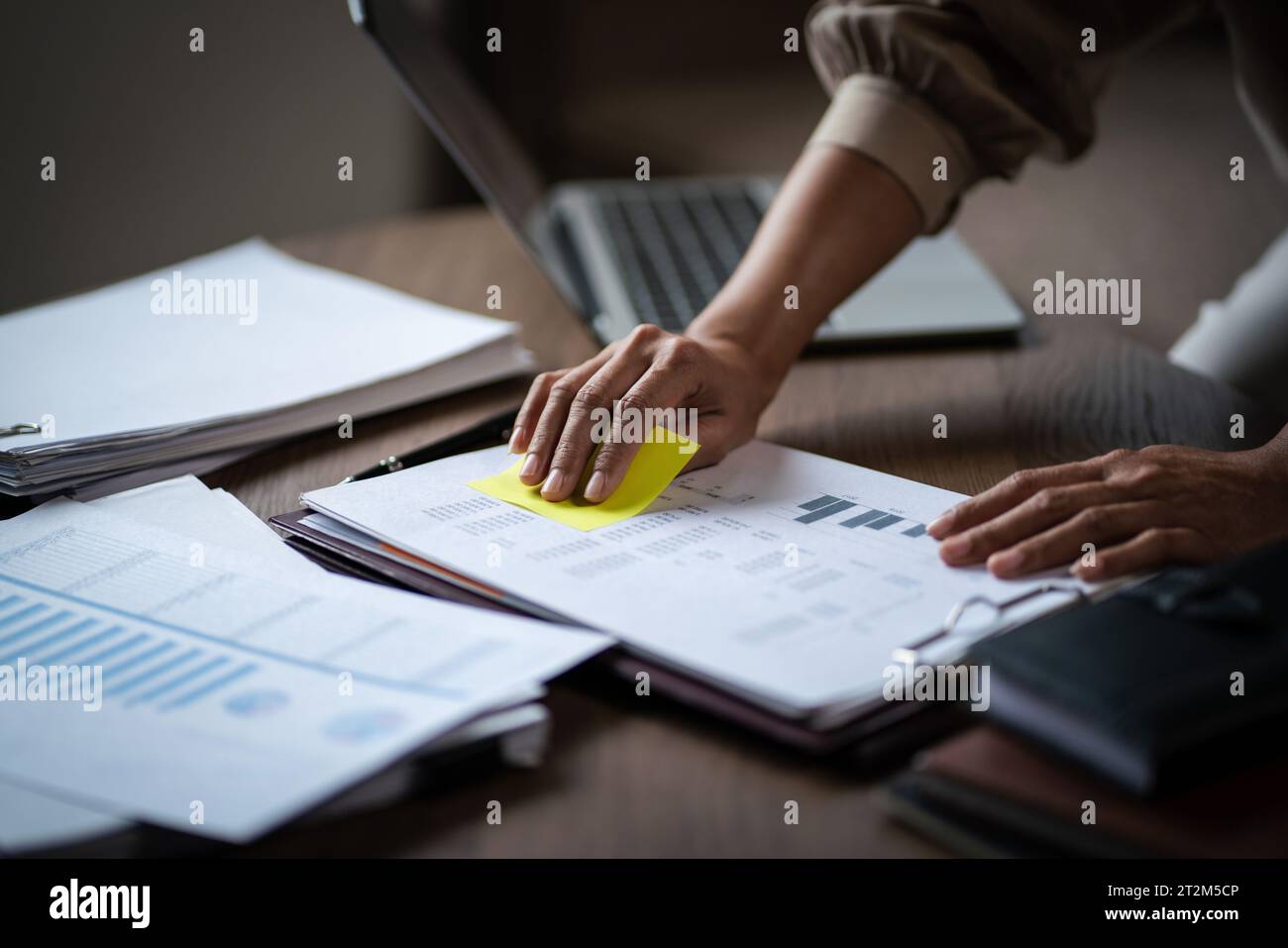 Female entrepreneur put memo sticky notes on document while working ...
