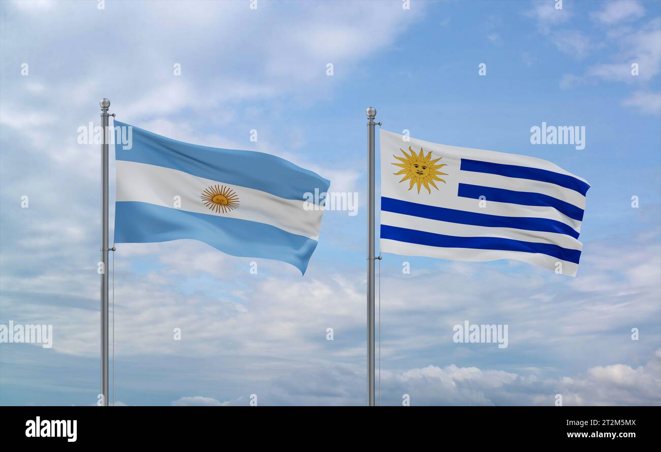 Uruguay and Argentina flags waving together in the wind on blue cloudy ...