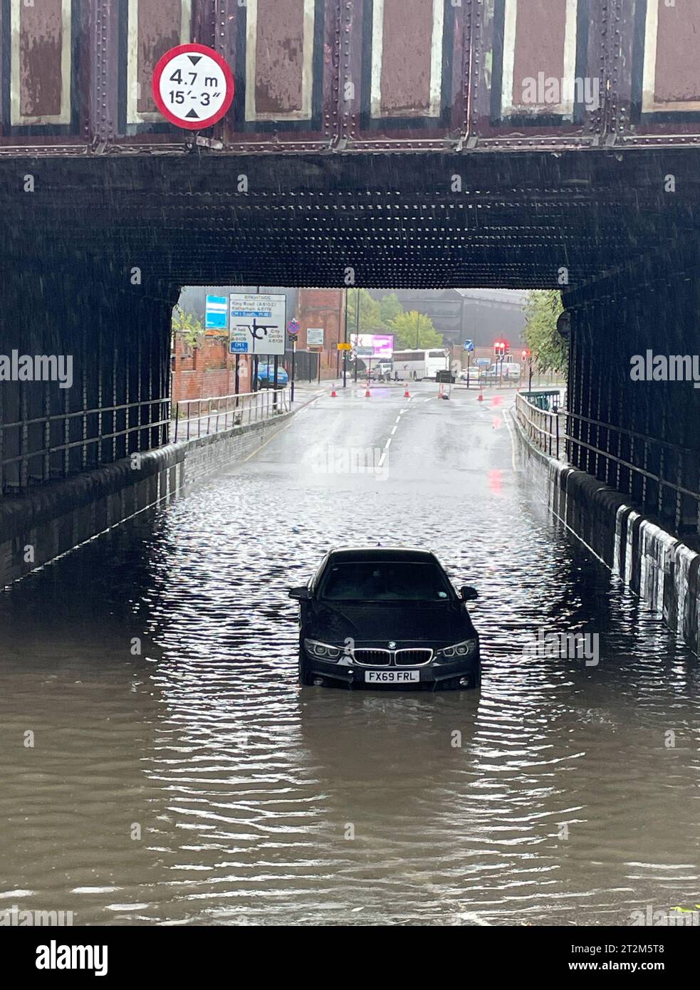 A car stuck in floodwater under a railway bridge at Upwell Street ...