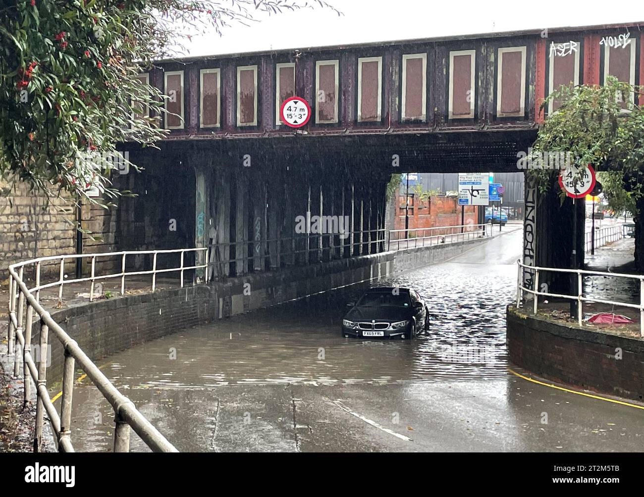 A car stuck in floodwater under a railway bridge at Upwell Street ...