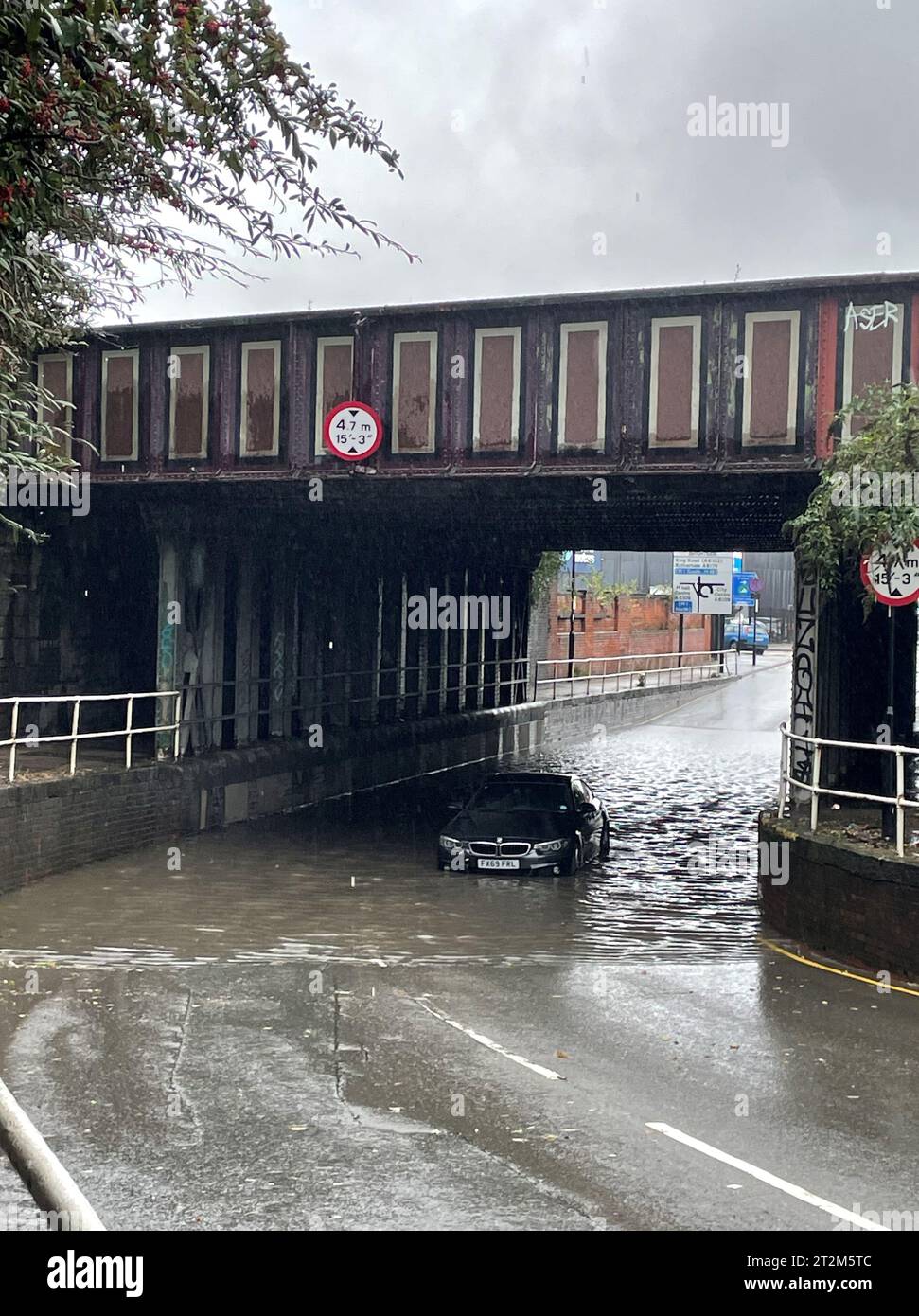 A car stuck in floodwater under a railway bridge at Upwell Street ...