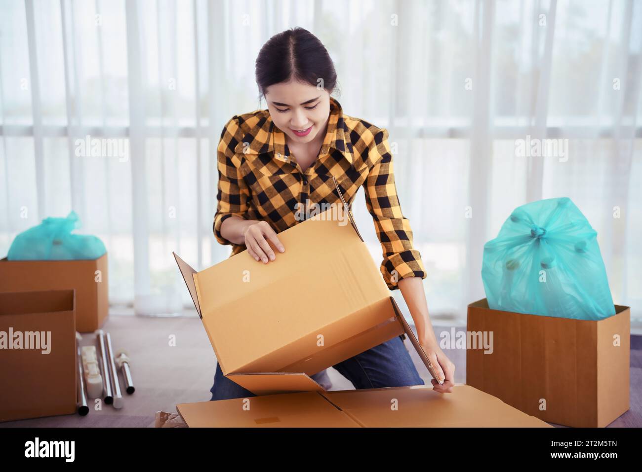 Women picking and sorting waste cardboard box to reuse and recycling ...