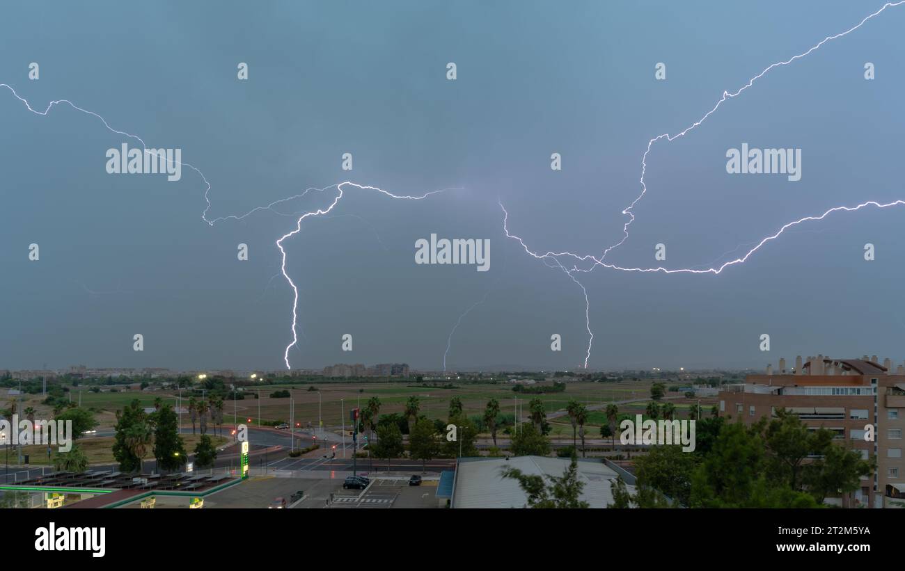 Stormy sky with several huge lightning bolts striking the ground on the ...