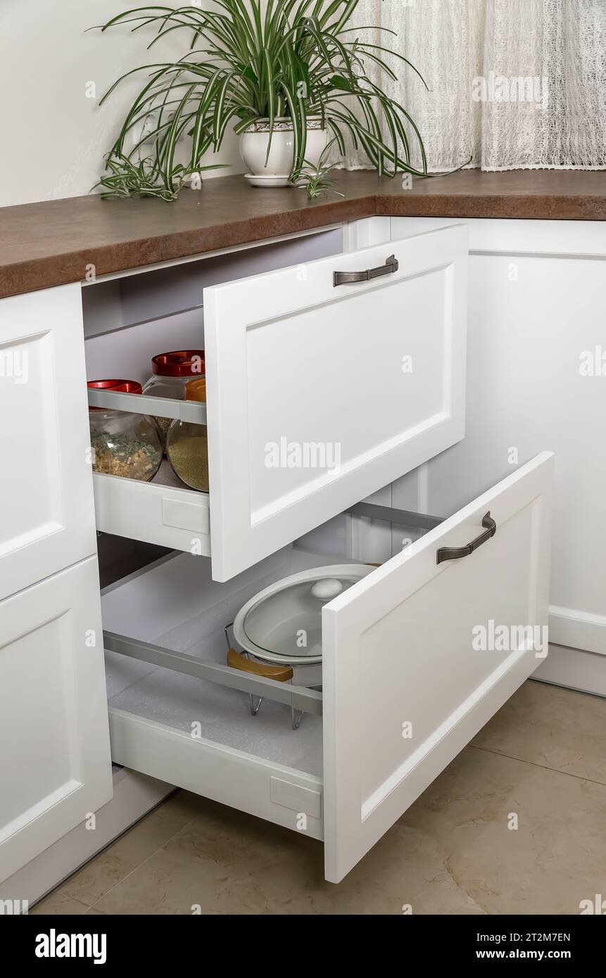 White drawers in kitchen set. Open drawers Stock Photo - Alamy