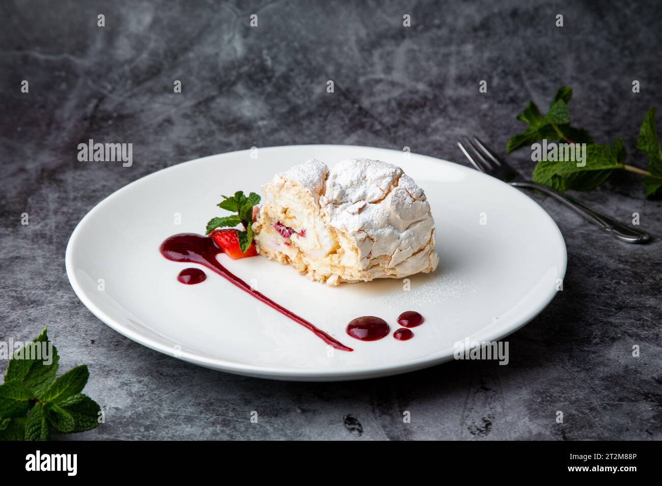 sweet sponge dessert with raspberries and powdered sugar side view ...