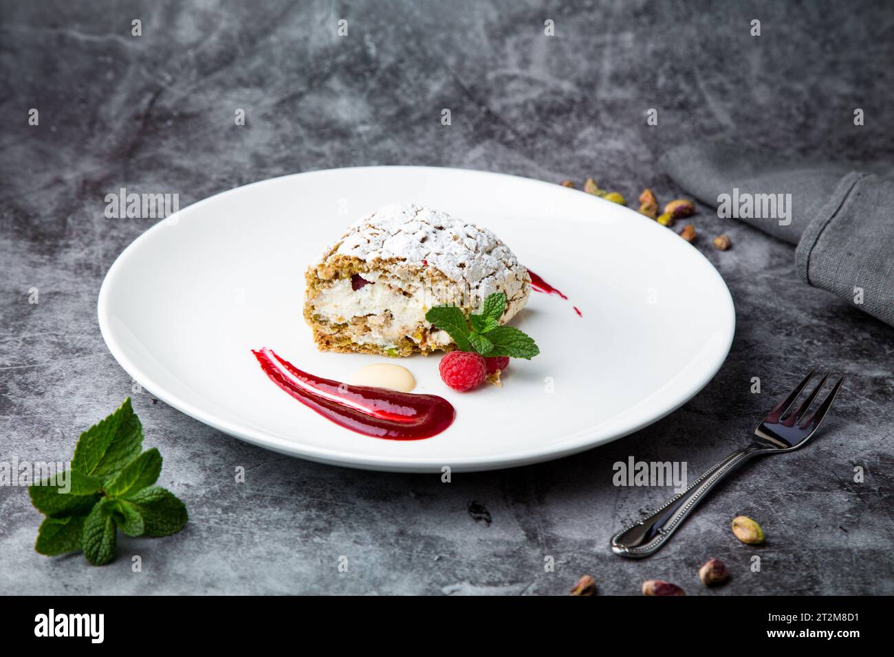 sweet sponge dessert with raspberries and powdered sugar side view ...