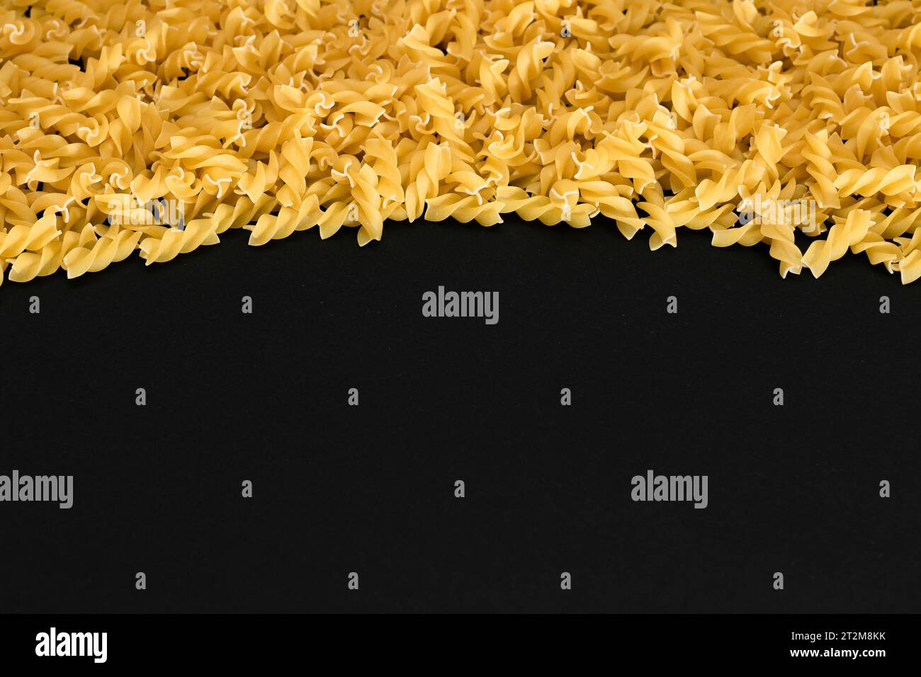 Uncooked Fusilli Pasta with Copy Space on Black Background. Raw and Dry ...