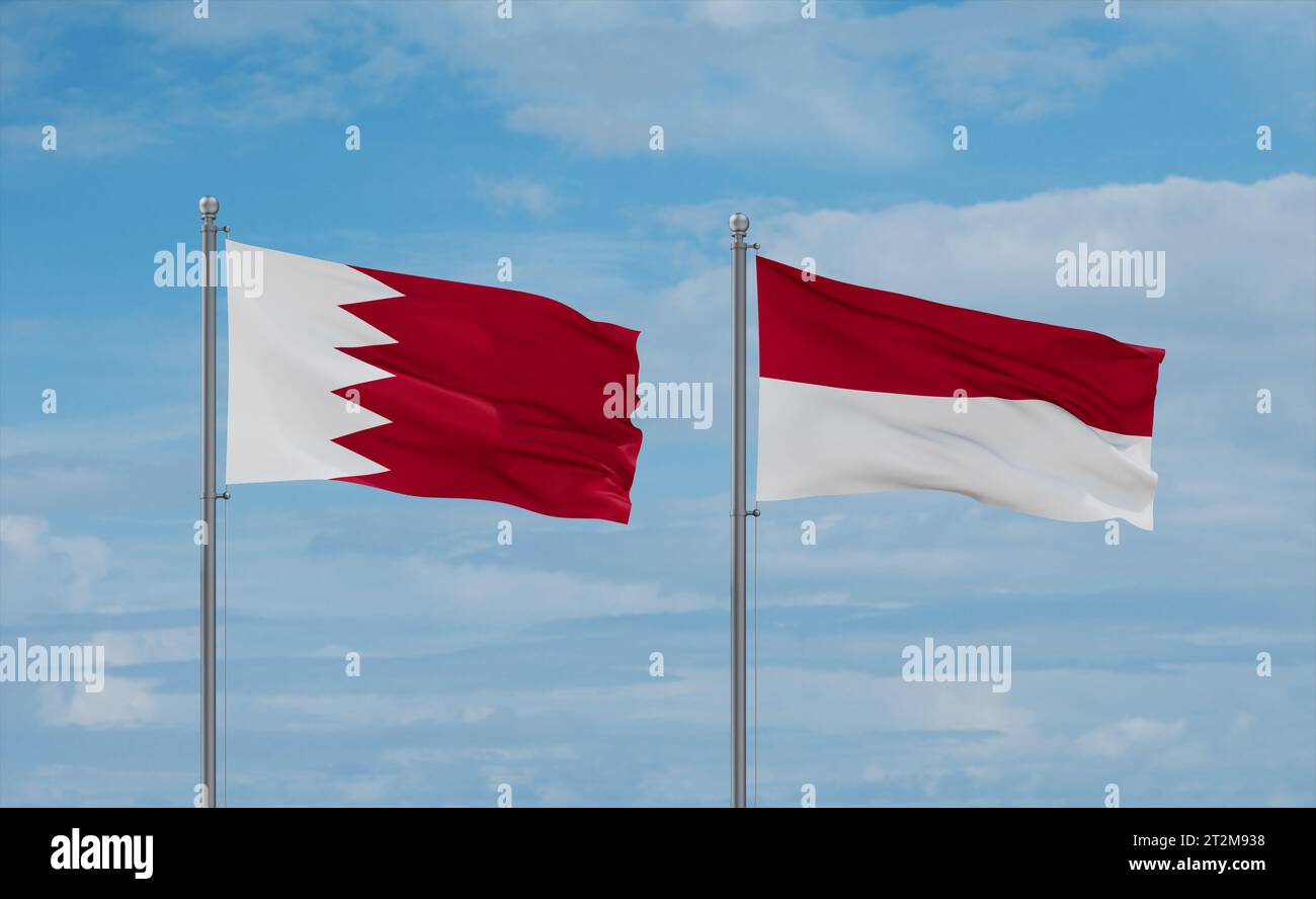 Indonesia and Bahrain flags waving together on blue cloudy sky, two ...