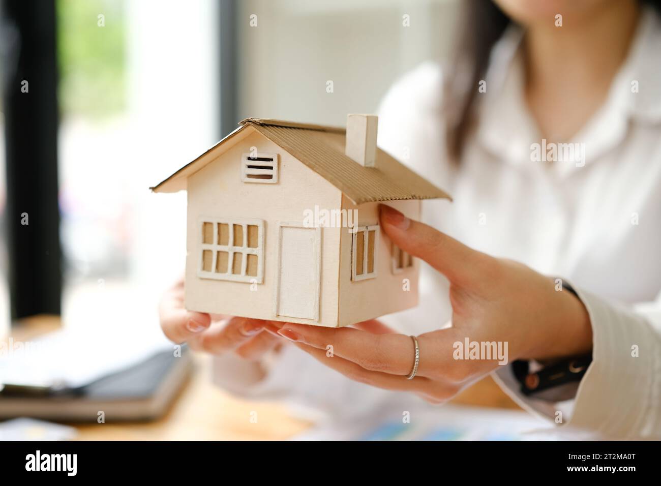 woman showing model of house that she plans to sell concept ai ...