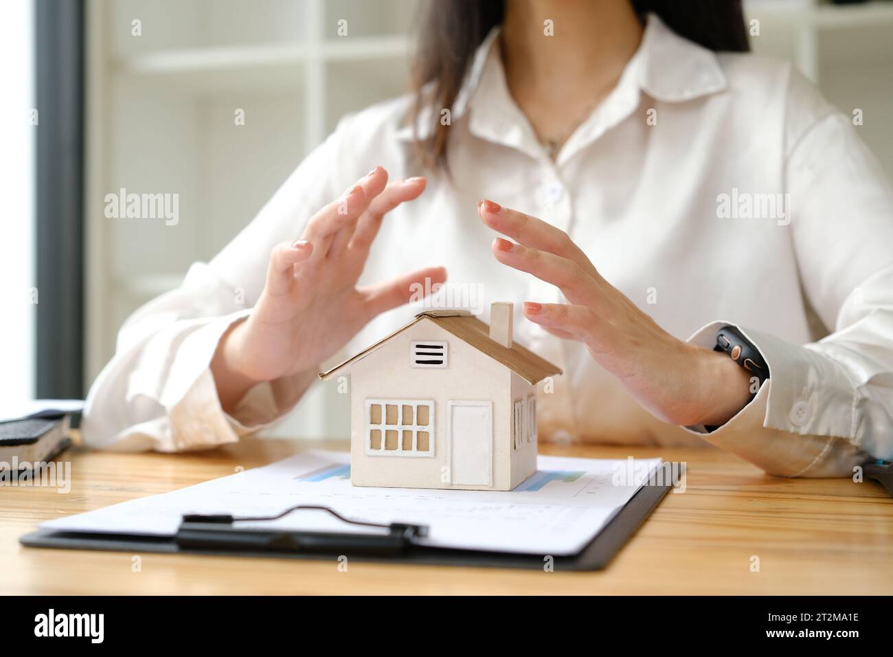 woman showing model of house that she plans to sell concept ai ...