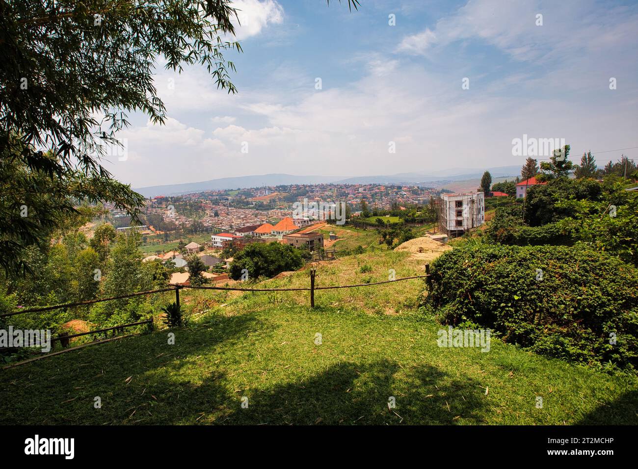 A scenic, panoramic view of a vibrant cityscape from the top of a hill ...