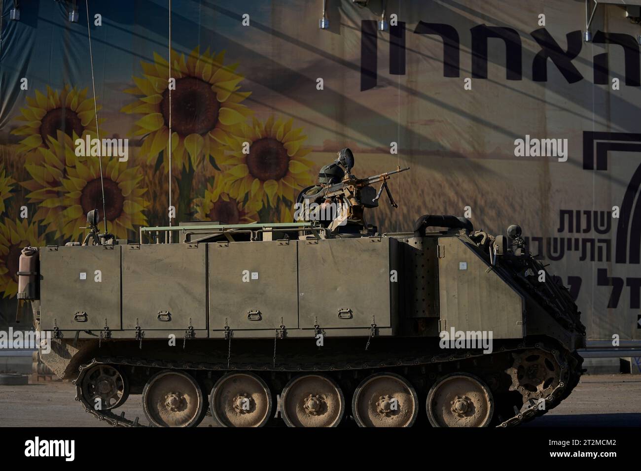 Israeli soldiers move an armored personal carrier (APC) at a staging ...