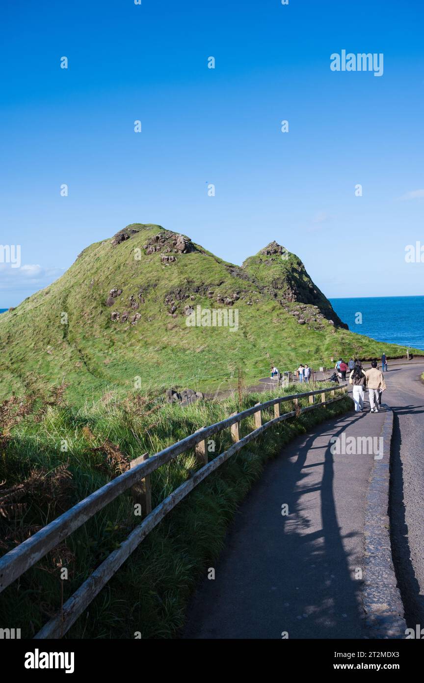 People walking the coastal trail leading to the Giants Causeway. County ...