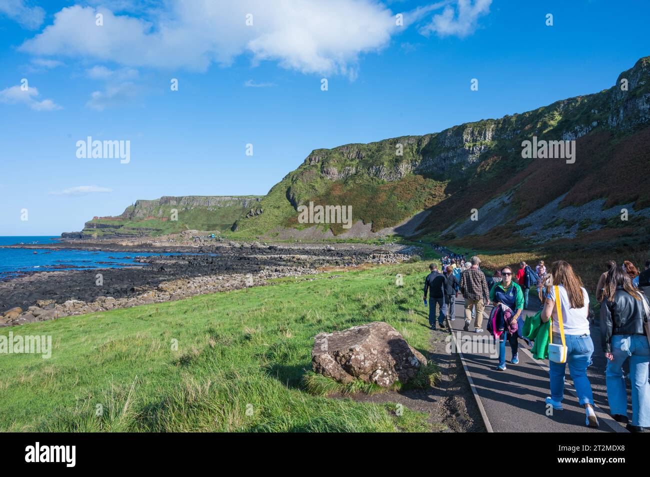 People walking the coastal trail leading to the Giants Causeway. County ...