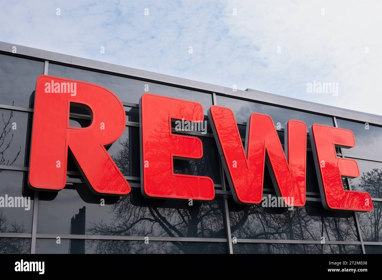 Facade with sign and logo of Rewe Stock Photo - Alamy