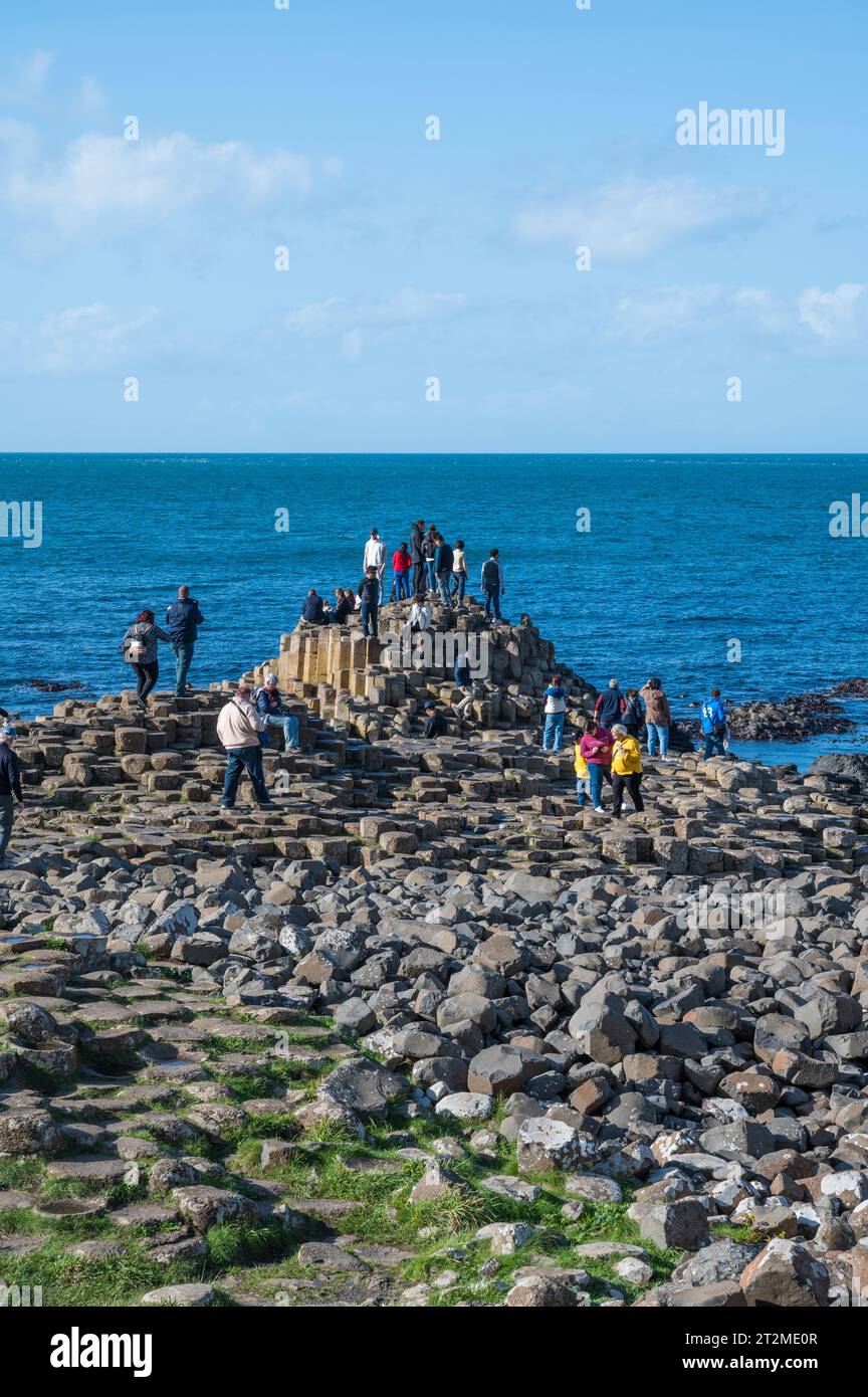 People climbing on the basalt columns of the Giants Causeway. Bushmills ...