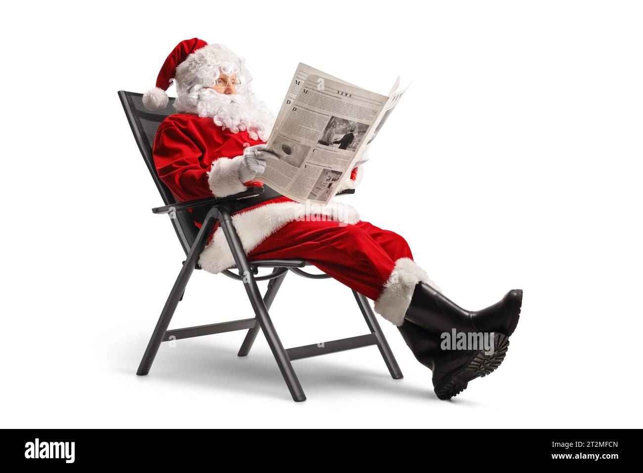 Santa claus sitting in a foldable chair and reading a newspaper ...