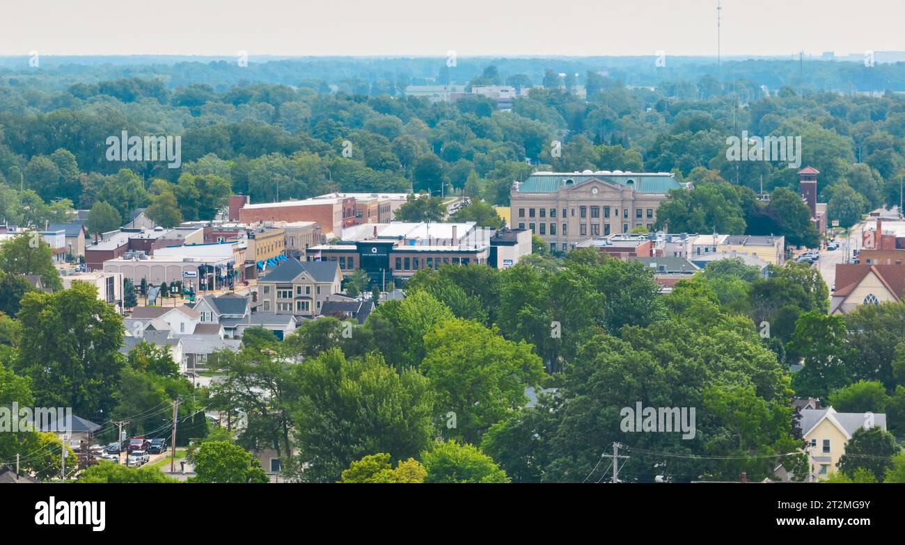 Wide view of downtown Auburn Indiana with courthouse in back and trees ...