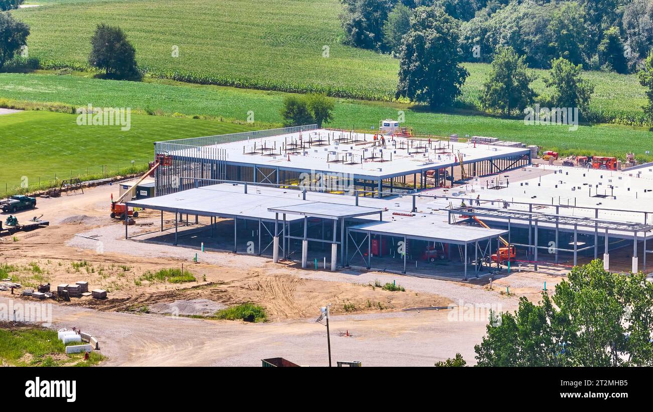 Construction workers building large building with metal support beams ...