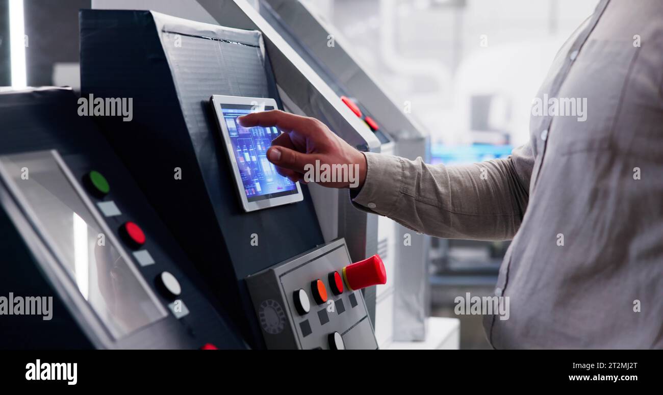 Print Operator At Factory Using Manufacturing Equipment Stock Photo - Alamy