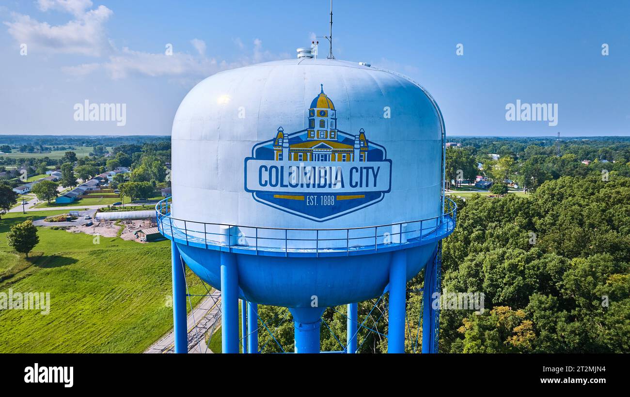 Aerial front view Columbia City EST 1888 water tower view with houses ...