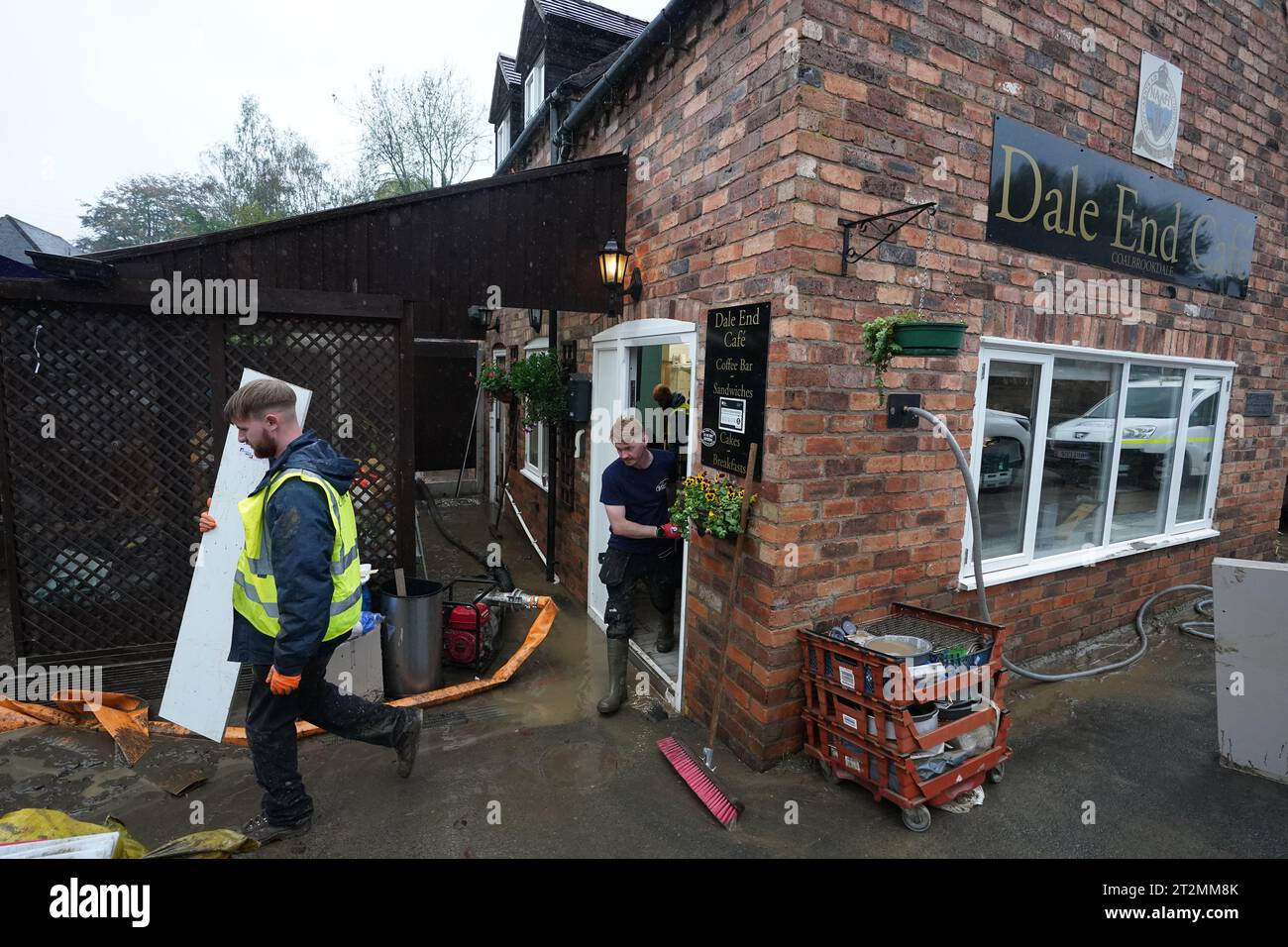 People clean up the Dale End Cafe in Coalbrookdale, Telford, after it ...