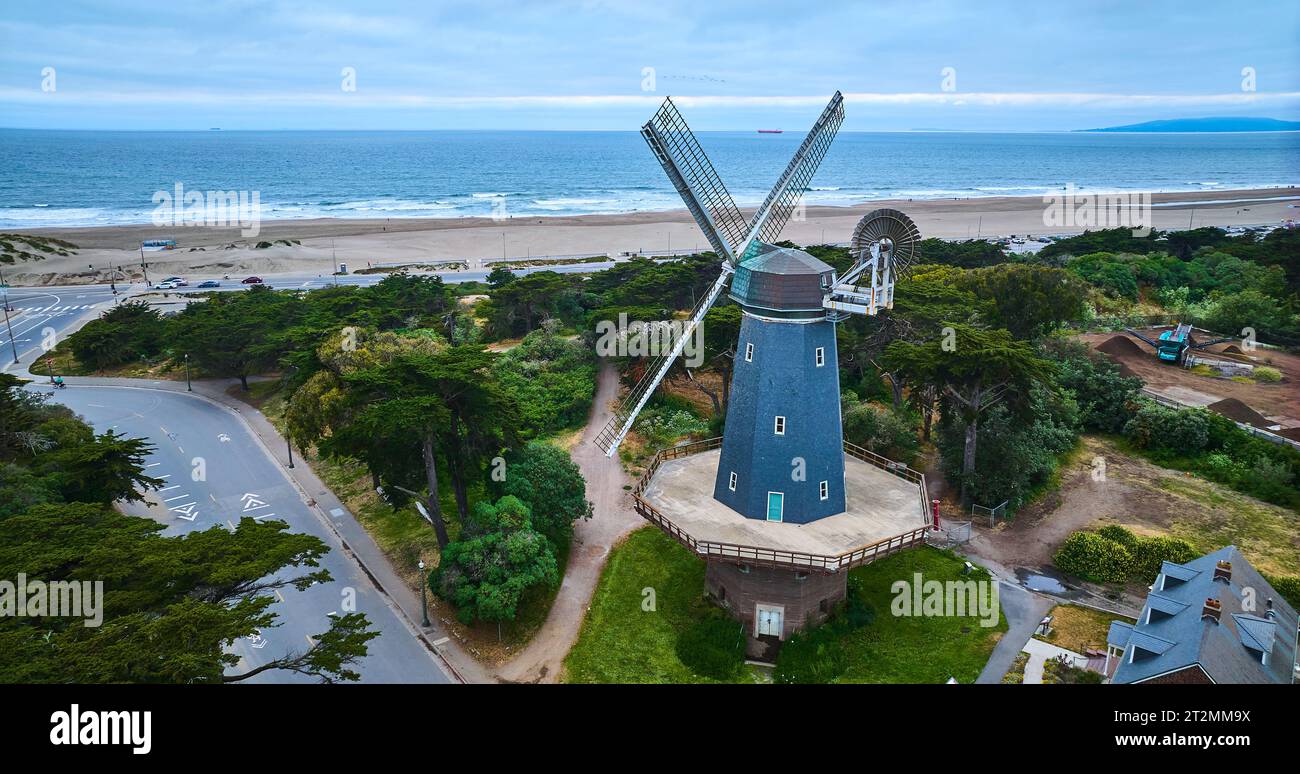 Blue murphy windmill surrounded by trees and roads overlooking blue ...