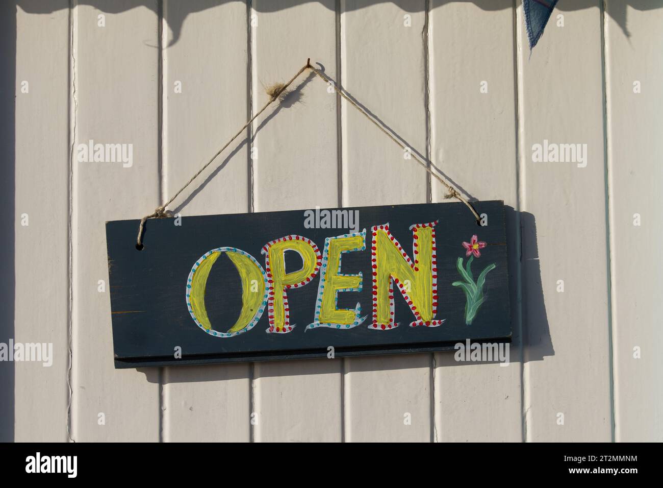 Colourful hand painted Open sign on wooden slatted wall Stock Photo - Alamy