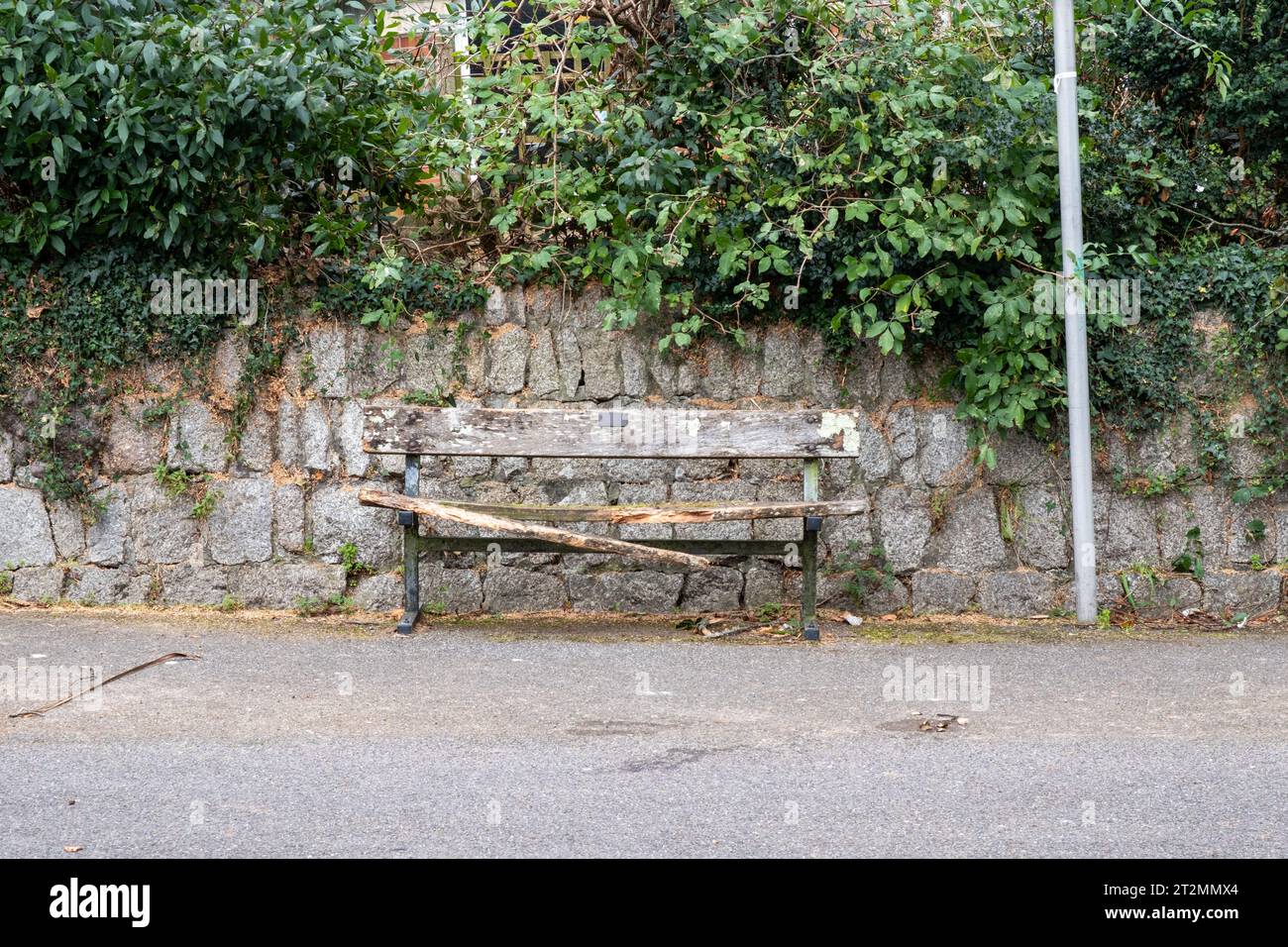 Broken wooden bench on the pavement Stock Photo - Alamy