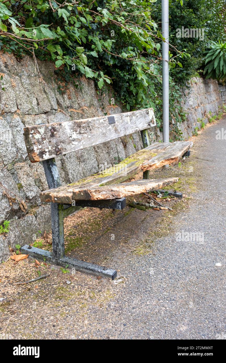 Broken wooden bench on the pavement Stock Photo - Alamy