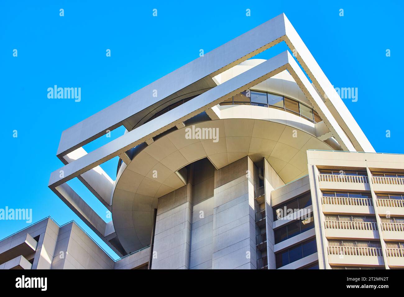 Unique circular roof of building upward view with clear blue sky behind ...