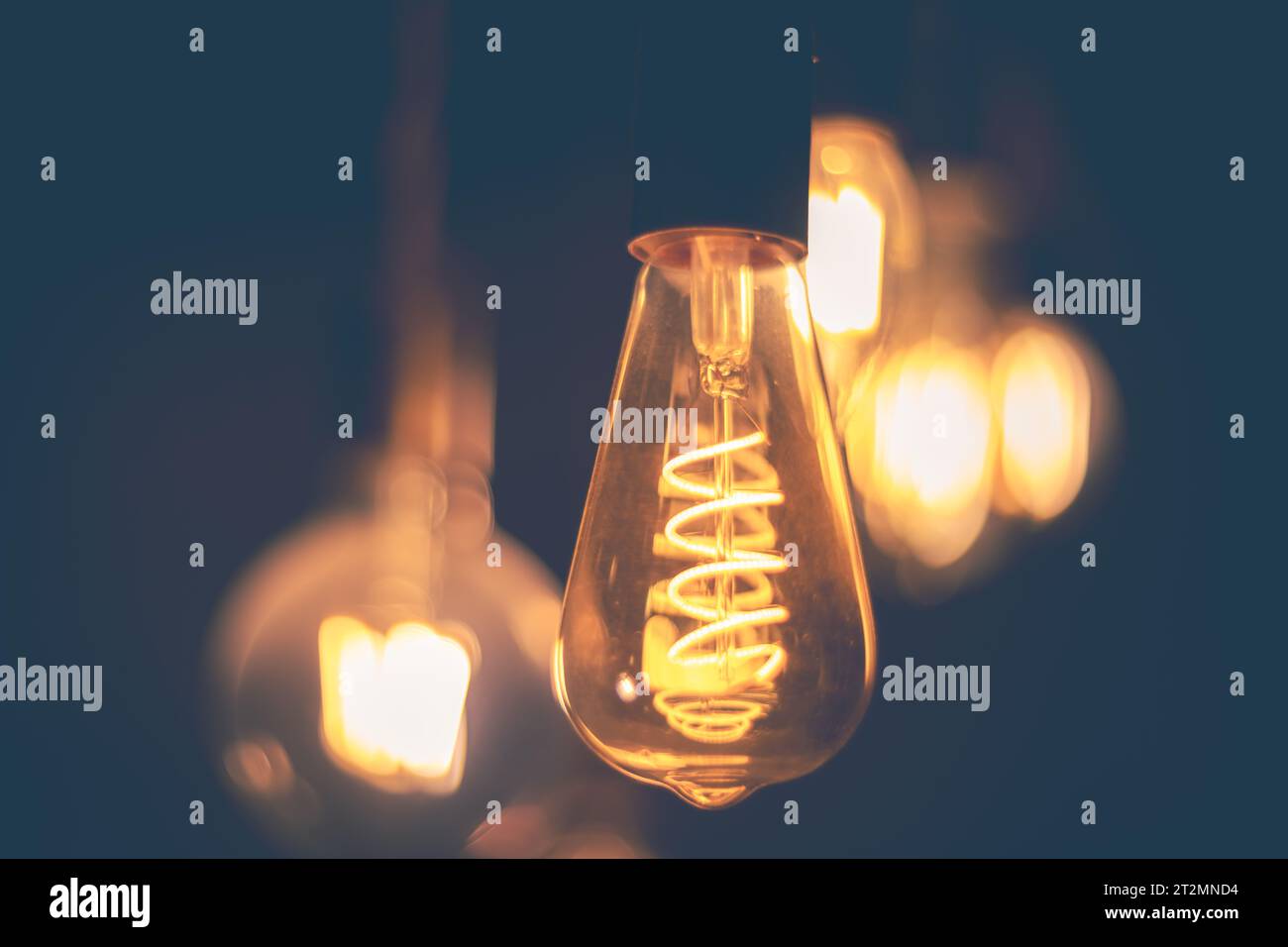 Spiral Retro LED light bulbs hanging on a dark background in interior ...