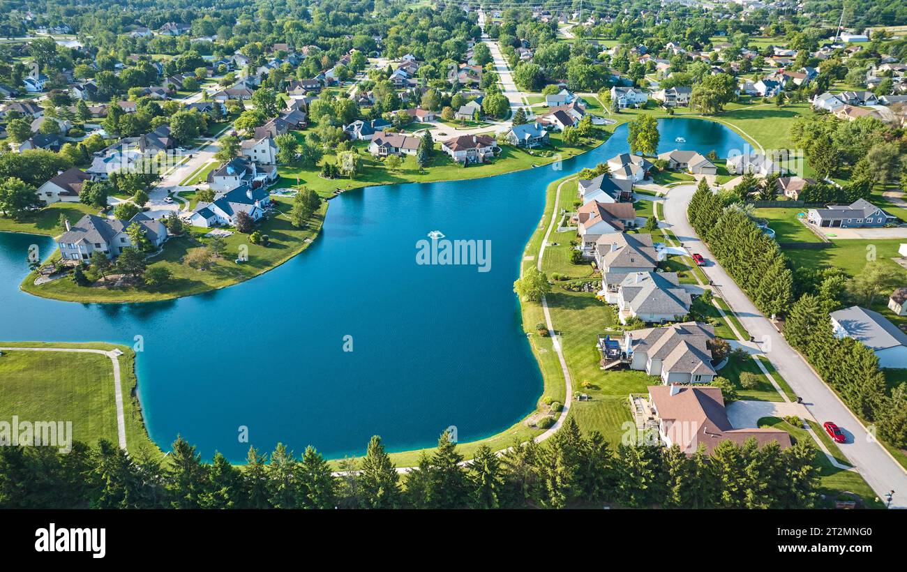 Wide view of expensive neighborhood with large pond and two water ...