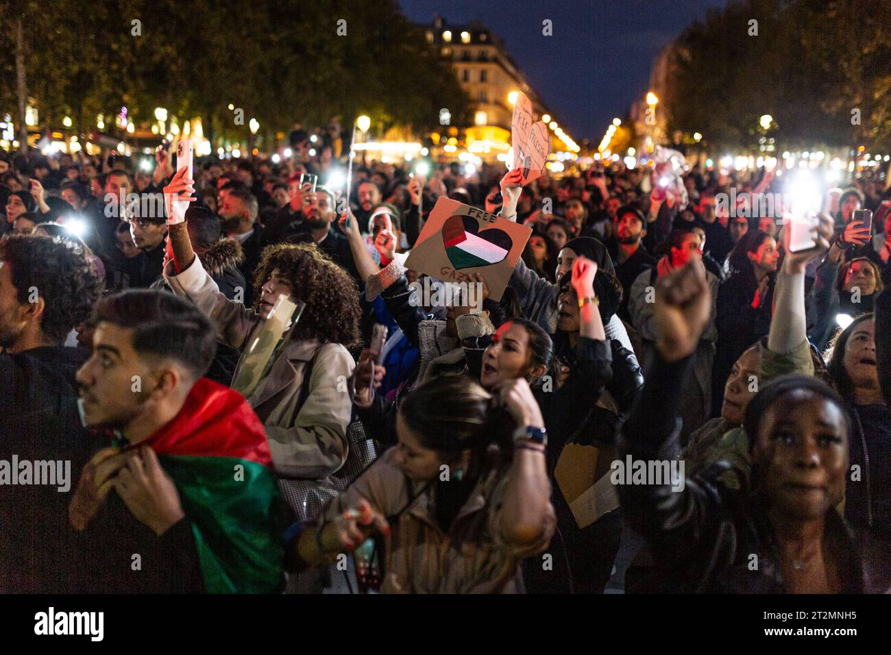 Crowd of protesters light mobile phone flashlights at Place de la ...