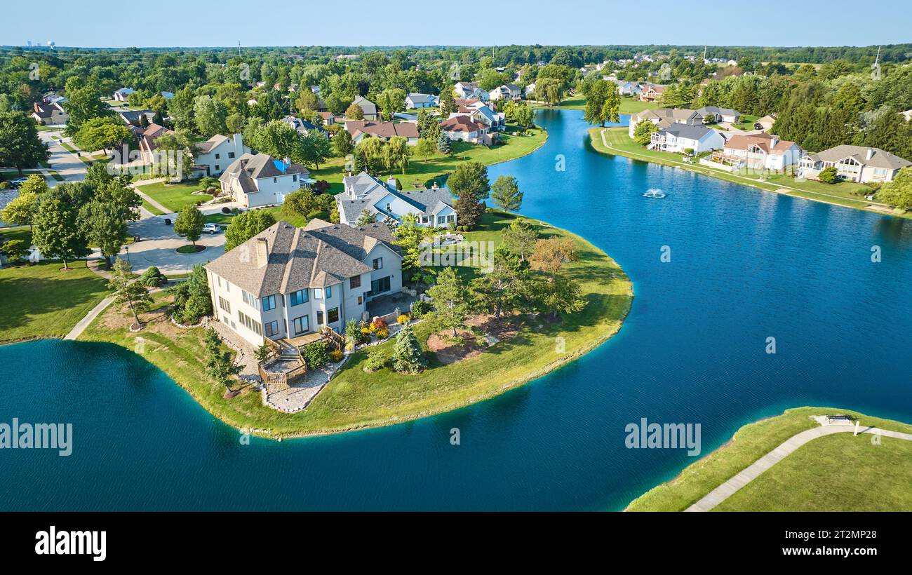 Aerial rich houses next to large man made pond with water fountain ...