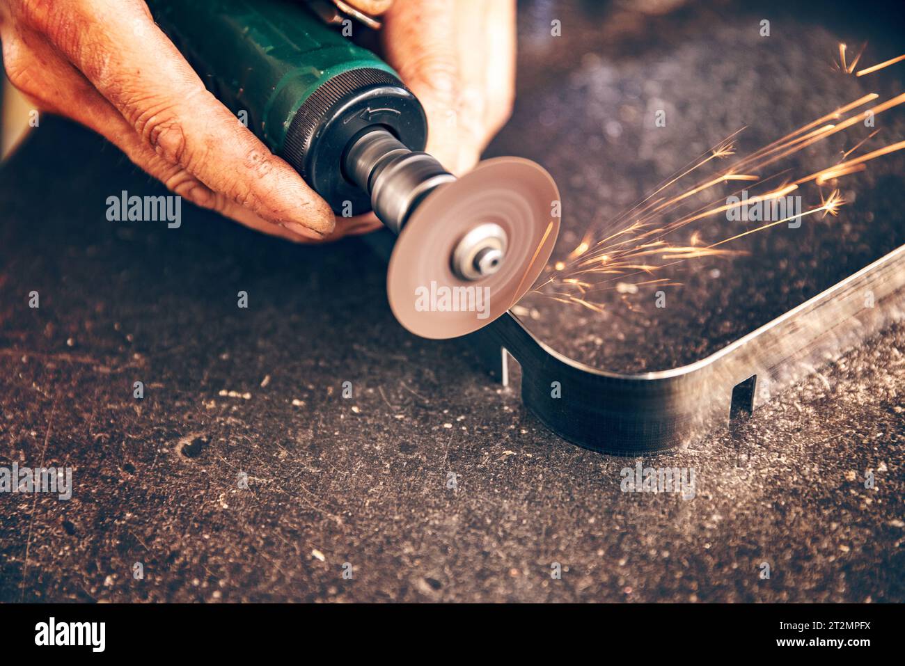 Worker cuts metal with metal sawing sparks flying during working with ...