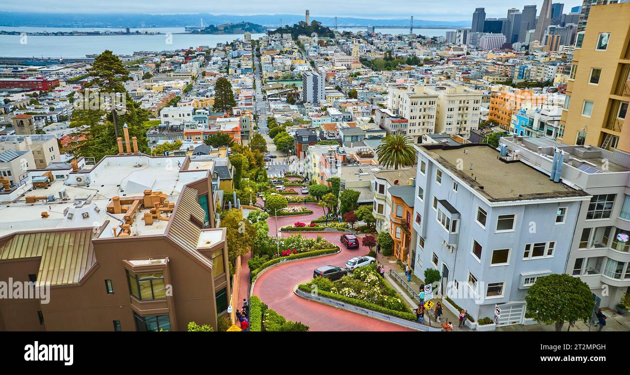 Aerial Lombard Street curving red brick road with cars and view of ...
