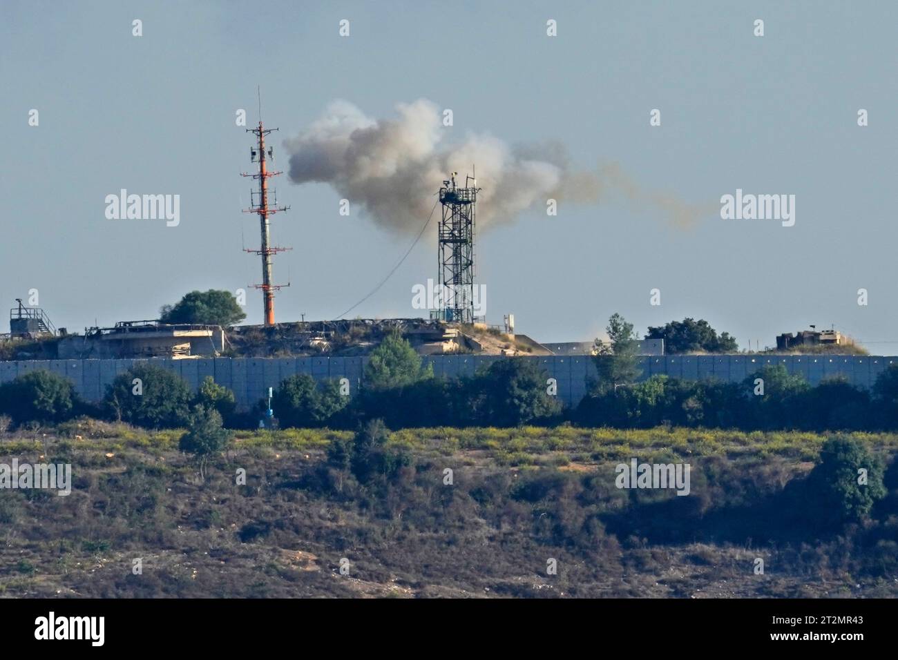 Smoke rises from inside an Israeli army position which was hit by ...