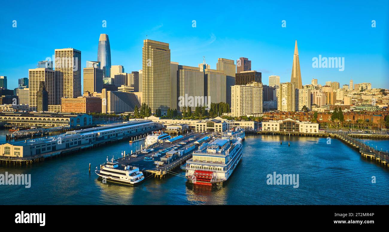 Aerial sunrise lighting over docked ships at Pier 7 with San Francisco ...