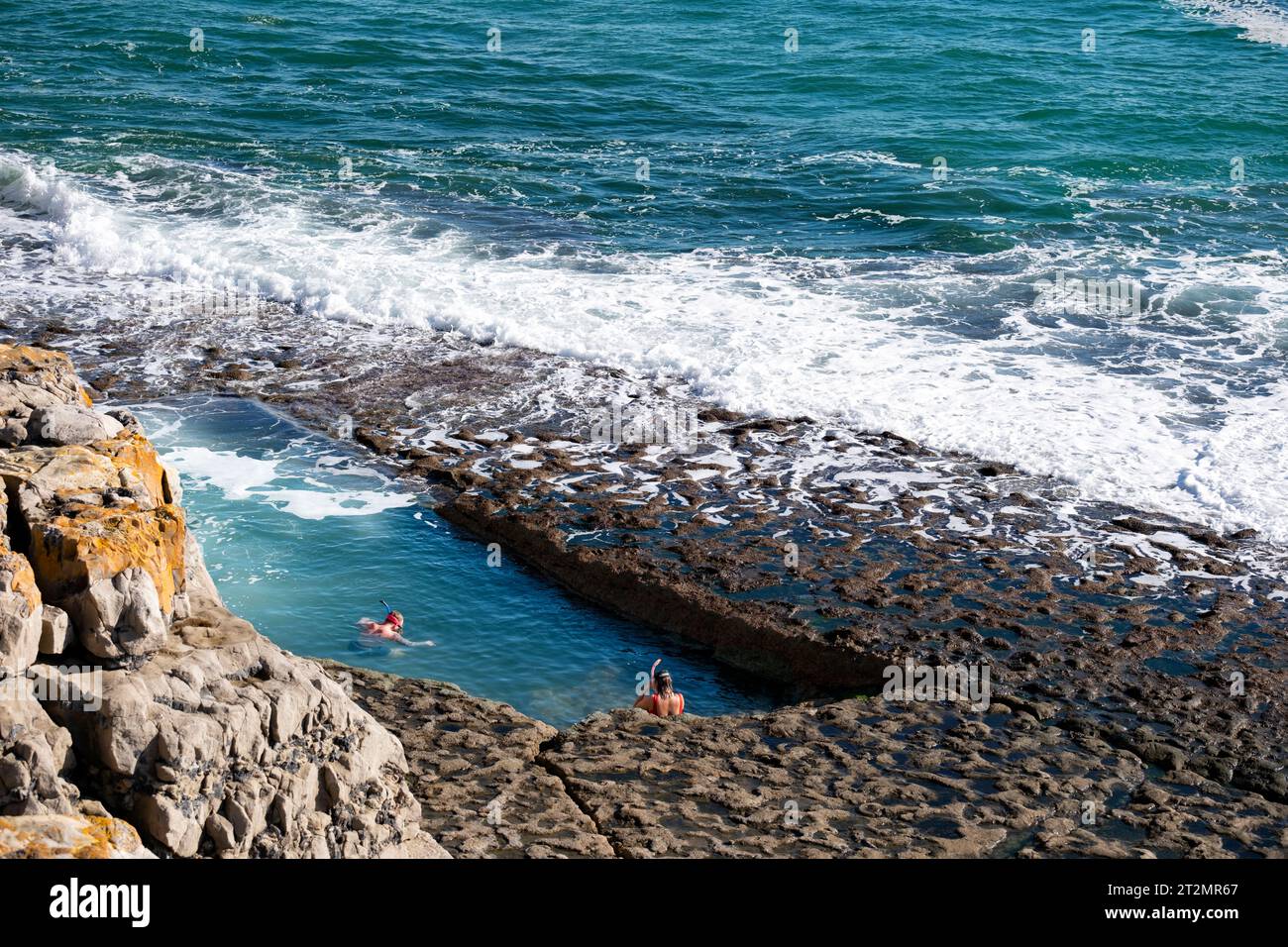 A couple swimming and snorkelling in the tidal pool that was created in ...