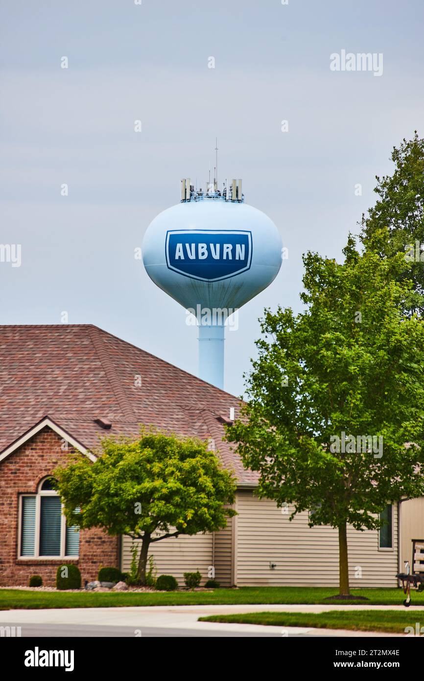 Auburn water tower behind suburban home with trees in front yard Stock ...