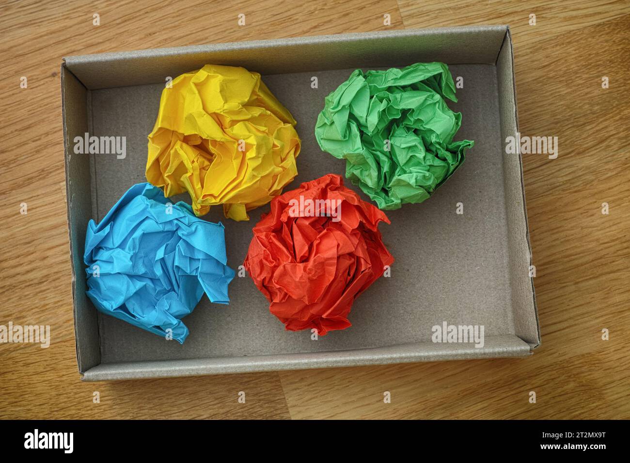 Colorful crumpled paper balls in a cardboard box. Idea Concept. Close ...