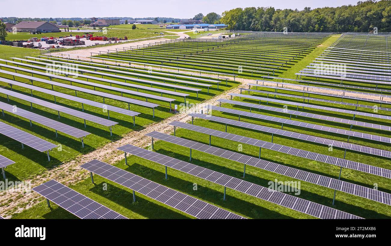 Low aerial of solar farm with panels on summer day in rural area of ...