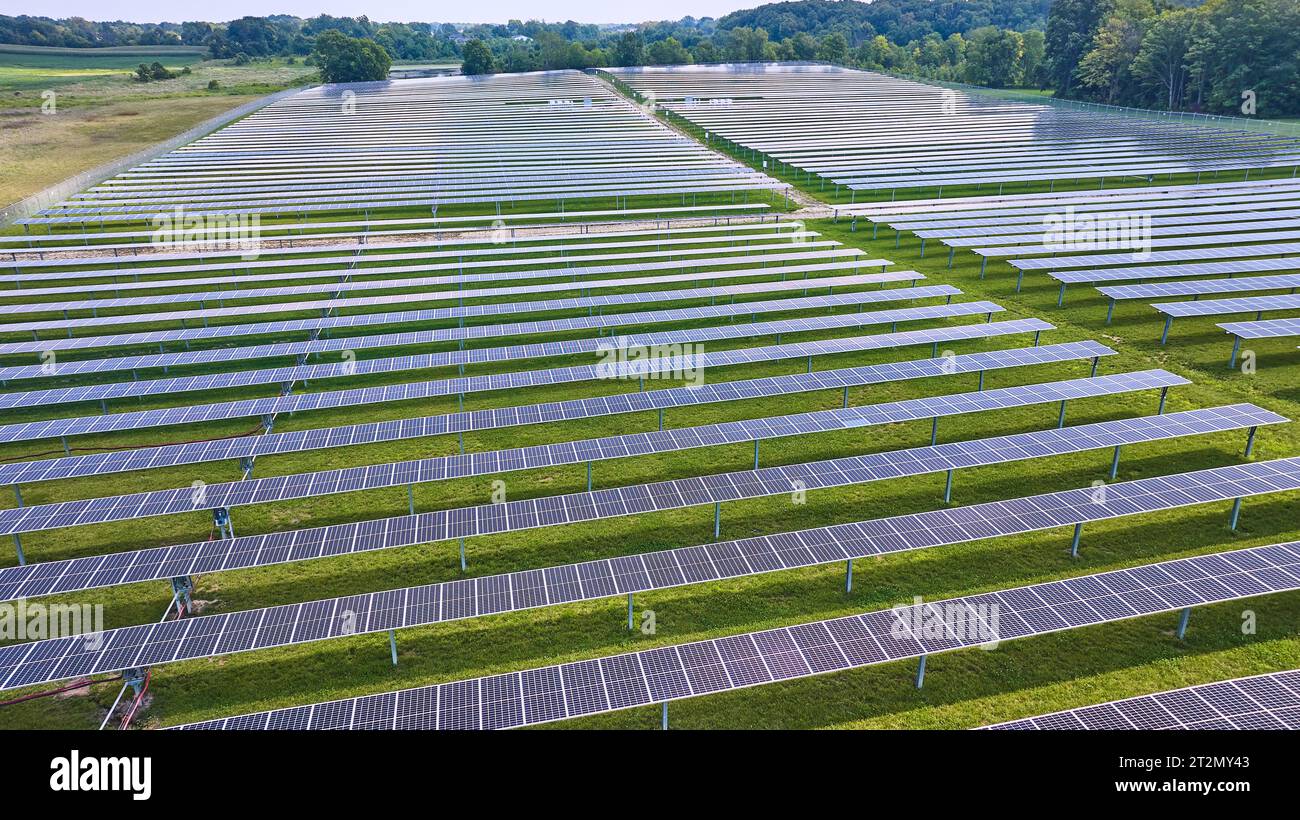 Aerial over horizontal rows of solar panels on solar farm Stock Photo ...