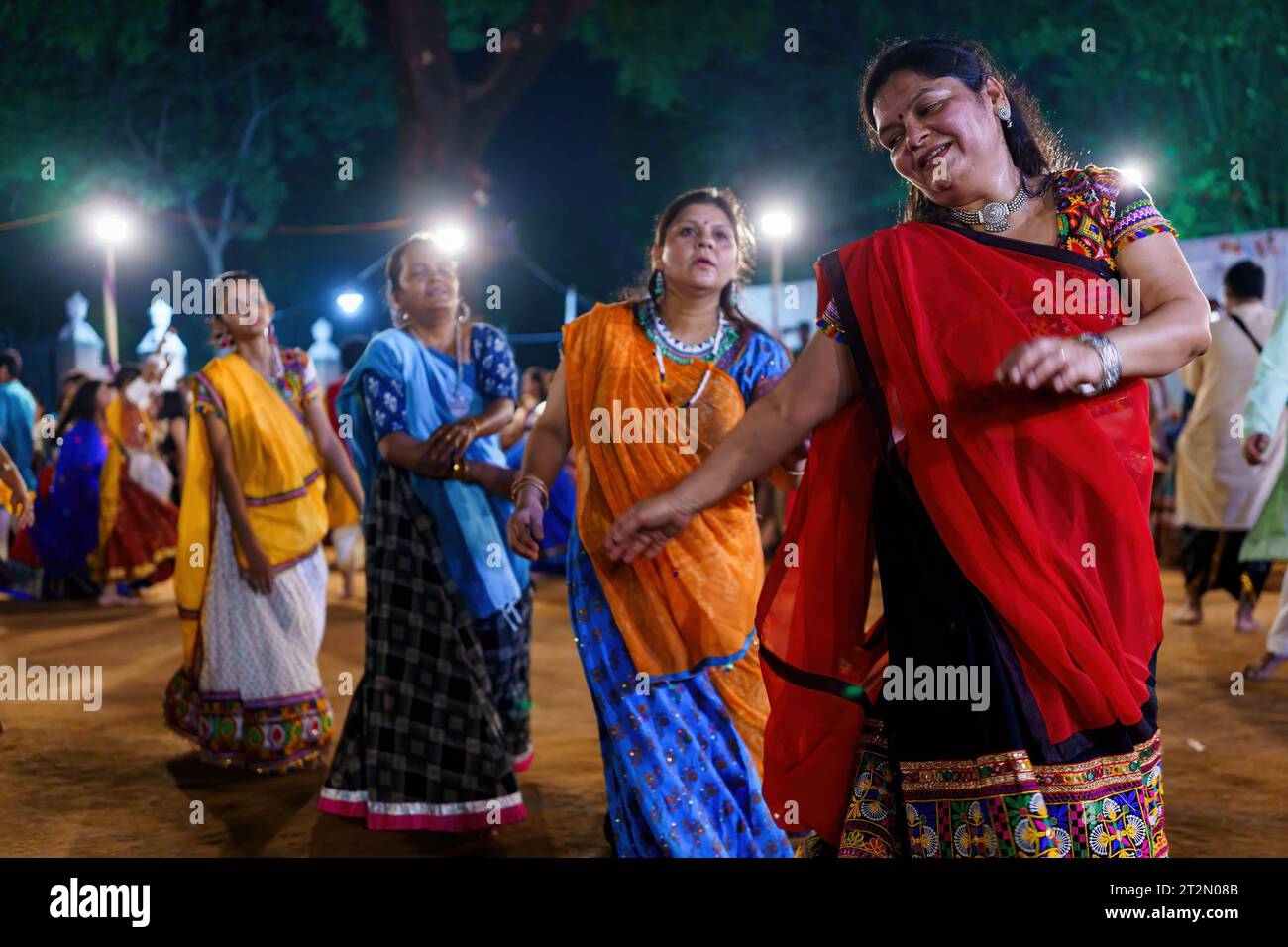Indian women in traditional clothes are seen dancing the traditional ...